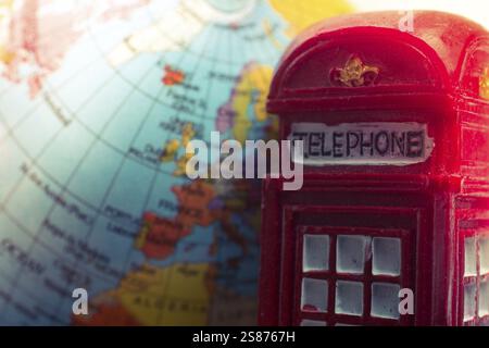 Model globe with a British telephone booth in view Stock Photo - Alamy