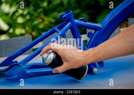 Spray Painting a Bicycle Frame Outdoors Stock Photo - Alamy
