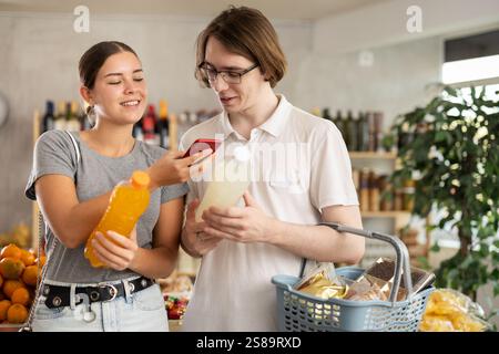Woman and man scanning drinks Stock Photo - Alamy