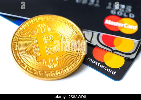 Gold bitcoin symbol and credit card master cards on the table. February ...