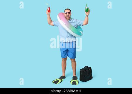 Happy office worker in flippers with inflatable ring, cocktail and ...
