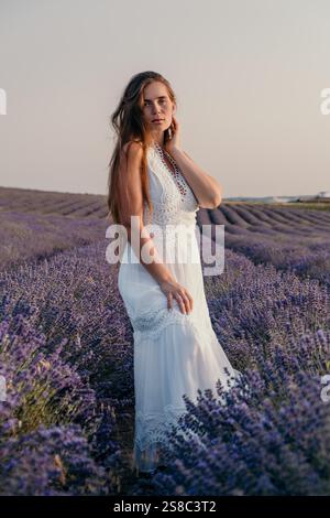 Provence, France. A girl in white dress walking trough lavender fields ...