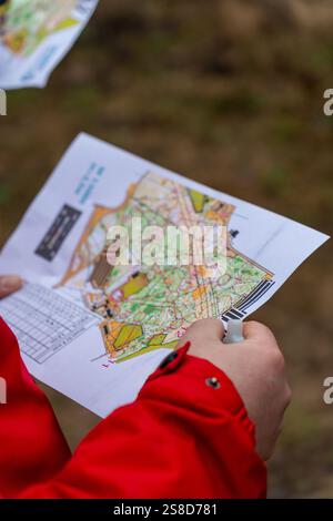 Athlete holding a map during orienteering competitions. Athlete uses ...