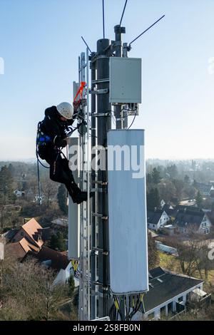21 January 2025, Bavaria, Fürth: A Deutsche Telekom technician carries ...