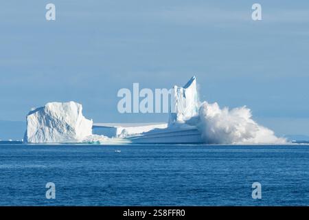 The arch of an iceberg collapses. This photo is one of several that ...