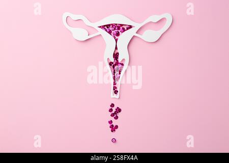 Menstruation. Paper uterus with sequins on pink background, top view ...