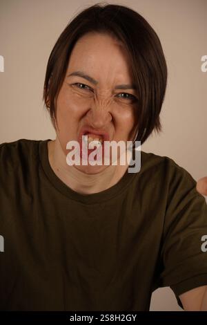 Disgust woman with thoughtful expression making choice against pastel ...