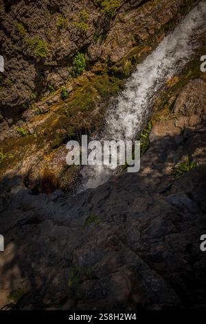 A waterfall dropping into hole in the rocks Stock Photo - Alamy
