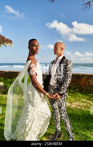 Ambiguous gender fluid couple in white dress, bold suit exchange rings ...