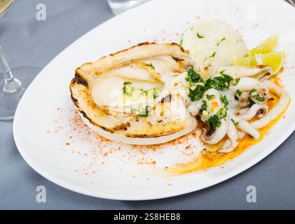 Fried cuttlefish served with rice Stock Photo - Alamy