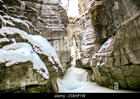 The view of a waterfall running through the rocks of the forest Stock ...