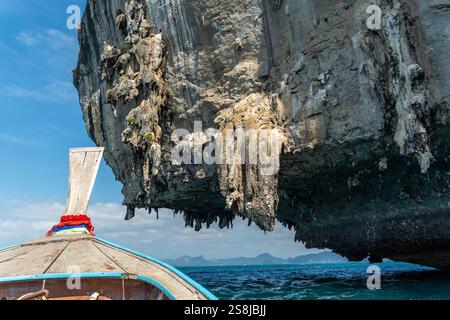 Scenic boat ride under towering limestone cliffs in Thailand's stunning ...