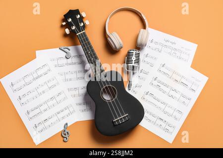 Ukulele, modern headphones and music sheets on color background Stock ...