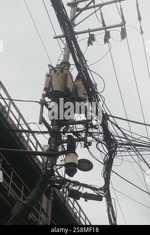Tangled electrical wires and tangled communication lines on urban ...
