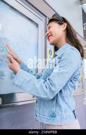 Happy young woman with a city map on bike in european city Stock Photo ...