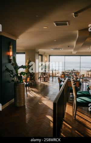 An empty cafe filled with chairs and tables along with interior ...