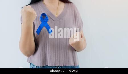 Young Asian woman with purple ribbon on lilac background. World Cancer ...