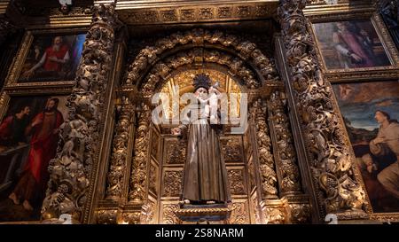 A decorated Catholic altar featuring a framed photo of Saint Carlo ...
