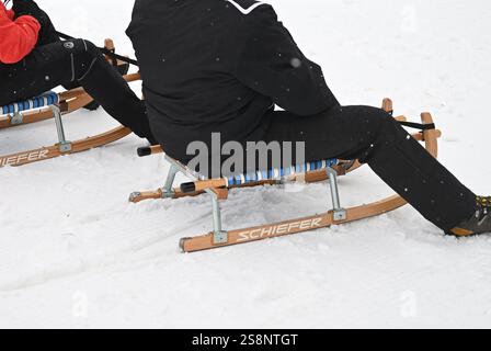 Rottach Egern, Germany. 23rd Jan, 2025. A man pulls his sledge ...
