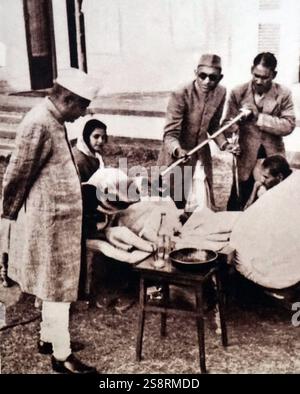 Mahatma Gandhi during a hunger strike is accompanied by Indira (Nehru ...