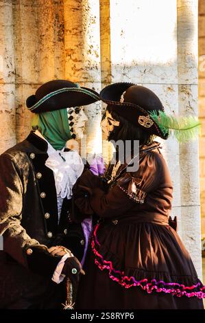 Two noble masks with Doge's Palace at background. St Mark's Square ...