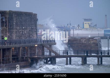 A jogger takes a dangerous run along the millennium promenade in front ...