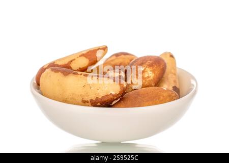 Brazil nuts without shells with ceramic saucer and wooden spoon, macro ...