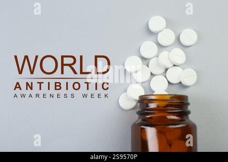 World antibiotic awareness week. Bottle and scattered pills on ...