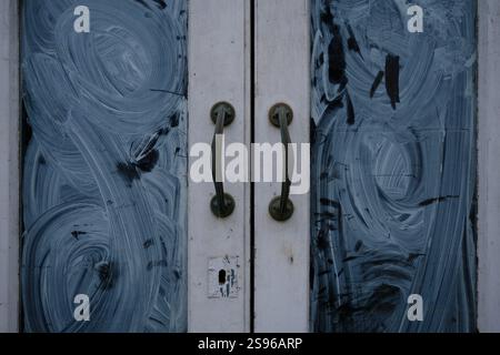A closed shop for renovation with white washed windows Stock Photo - Alamy