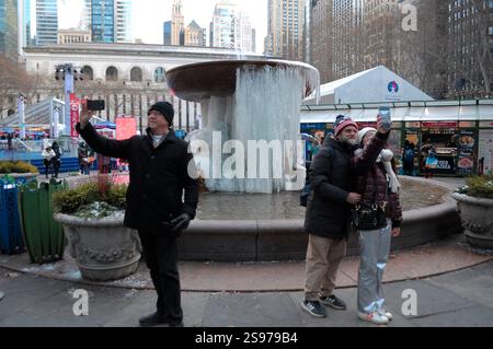 People take photos of the frozen fountain at Bryant Park during a ...