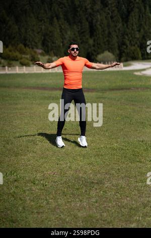 Man Practicing Dynamic Warm-Up Movements On Grass In Nature Stock Photo ...