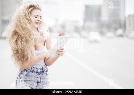 Old books, supplies and headphones on wooden table and blackboard for ...