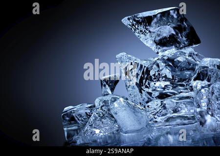 Frozen block of ice with blue tinted background Stock Photo - Alamy