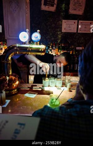 Greek bartender mixing cocktails at the counter of Odori Bar, Athens ...