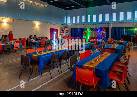 A sports hall set up with table, chairs and decorations ready for a ...
