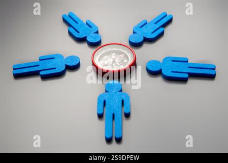 A compass surrounded by blue figures, symbolizing leadership, guidance ...