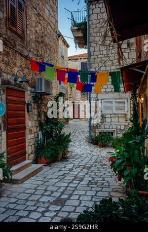 Coloured teeshirts hanging in cobbled streets, Old Hvar, Hvar, Croatia ...