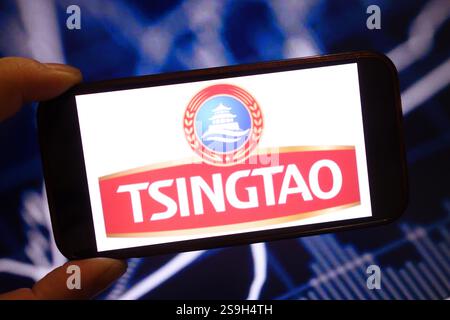 In this photo illustration, the Tsingtao company logo is seen displayed ...