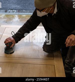 Using an electric sander for DIY Stock Photo - Alamy
