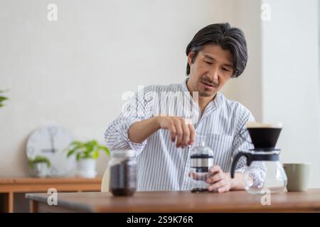 Man grinding coffee beans Stock Photo - Alamy