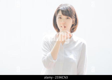 Young woman making the ‘secret’ hand sign Stock Photo - Alamy
