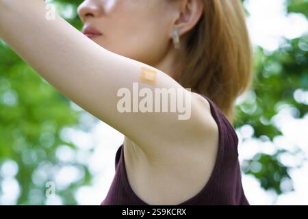 Woman's arm with patch after vaccination Stock Photo - Alamy