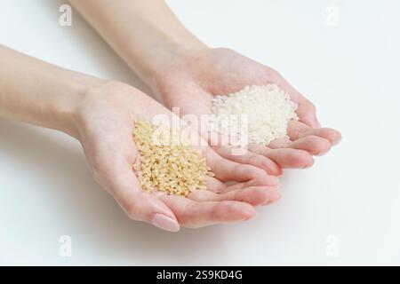 Hand with white rice and brown rice Stock Photo - Alamy