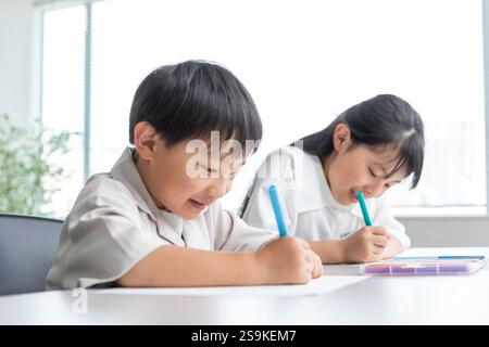 Primary schools student doing homework Stock Photo - Alamy