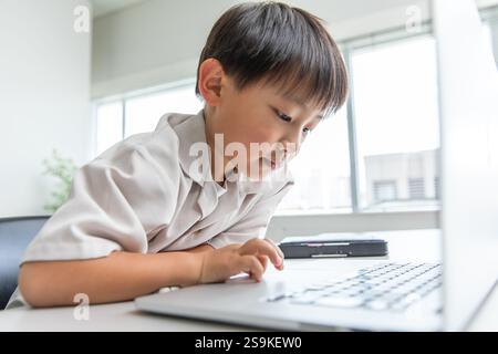 Child operating a computer Stock Photo - Alamy