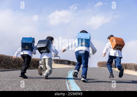 Elementary school student running away Stock Photo - Alamy