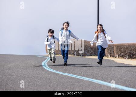 Elementary school student running away Stock Photo - Alamy