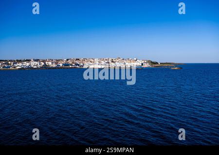Houses of the coastal town of Calasetta, seen across the Mediterranean ...