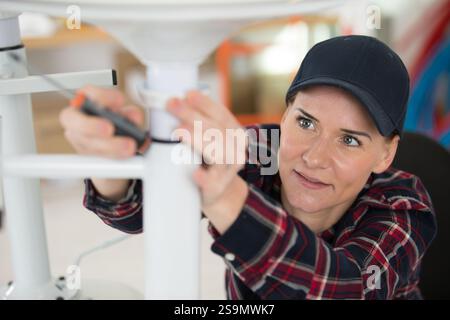female worker assembling metal stool Stock Photo - Alamy
