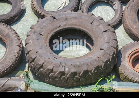 Used tires as a cover on a tarpaulin, Germany Stock Photo - Alamy